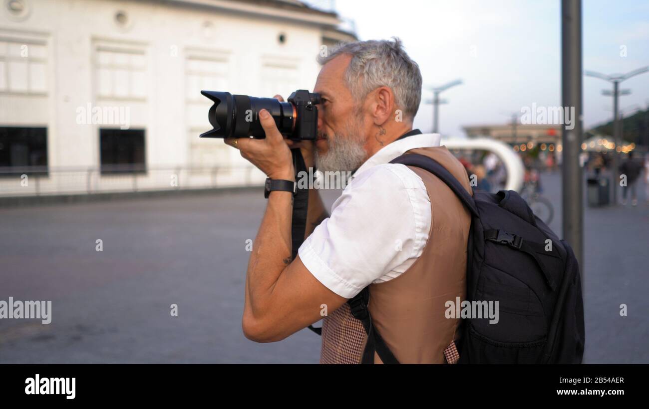 Attractive Man With Camera Takes A Picture While Traveling Stock Photo ...