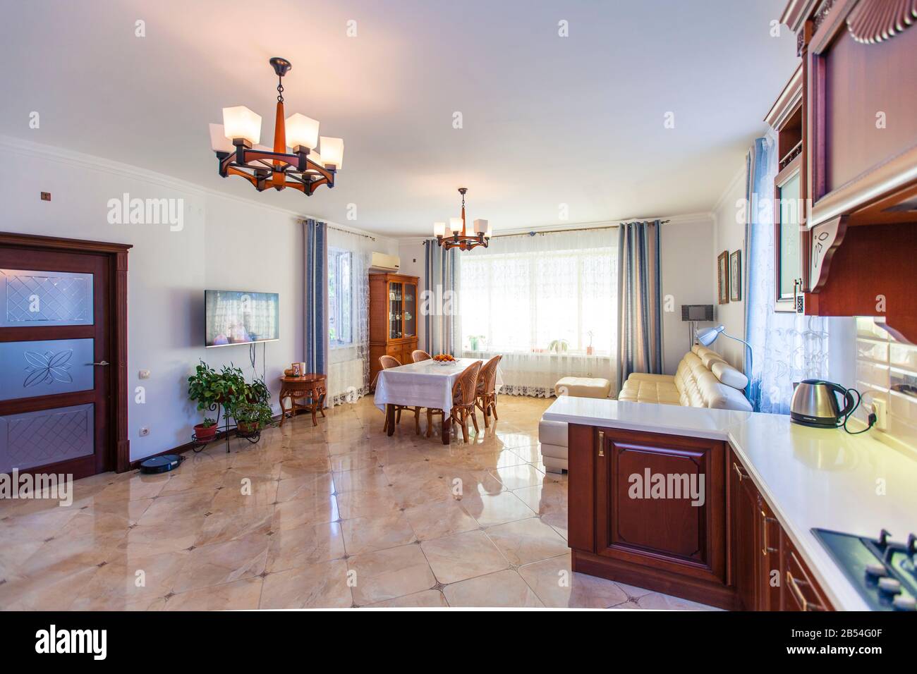 Large bright Sunny hall in the house. In the center of the room is a ...