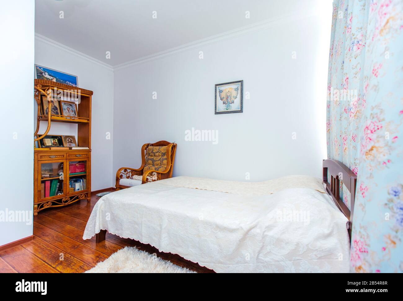 Prayer bedroom with a large double wooden bed, rocking chair and many ...