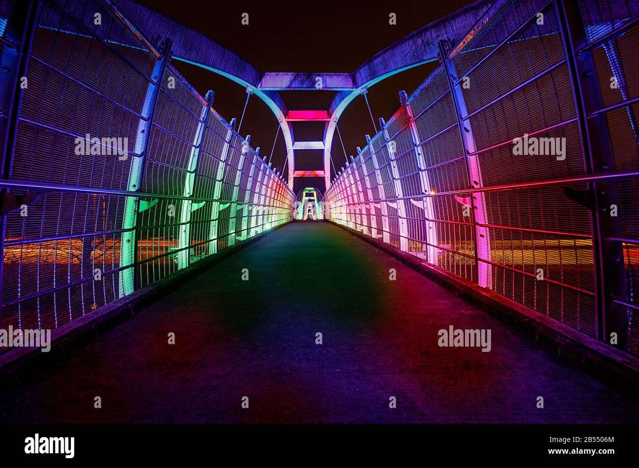Bright led illuminate pedestrian walkway over highway at night Stock ...