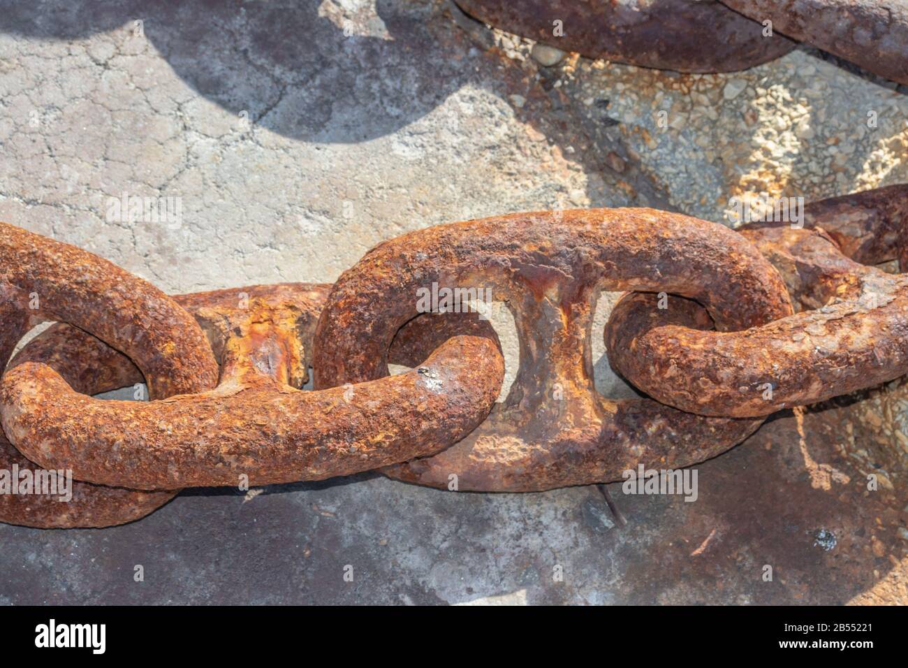 Huge old rusty chain link on a sunny day on asphalt Stock Photo - Alamy