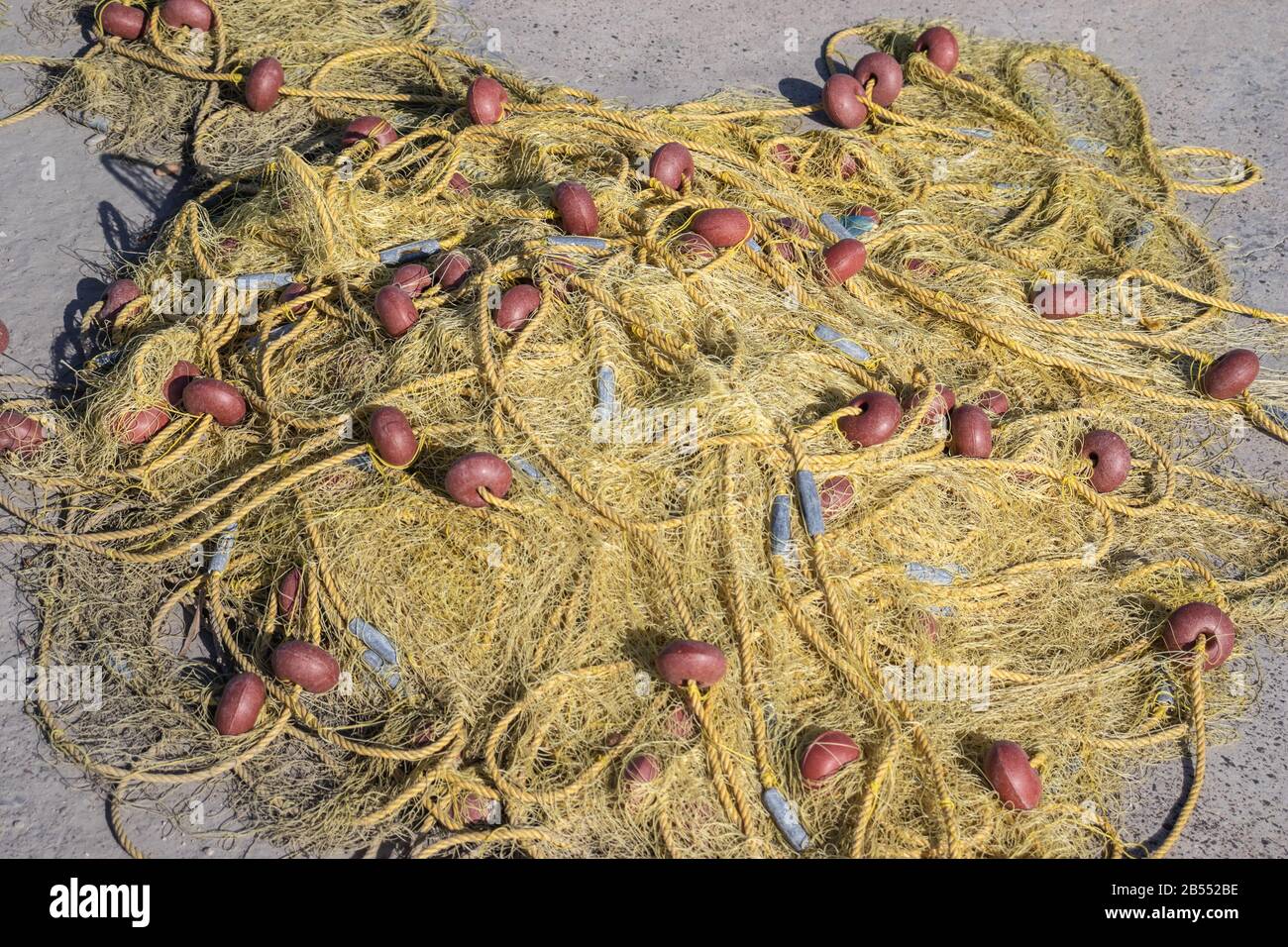 Pile of commercial fishing net with cords and floats as abstract ...