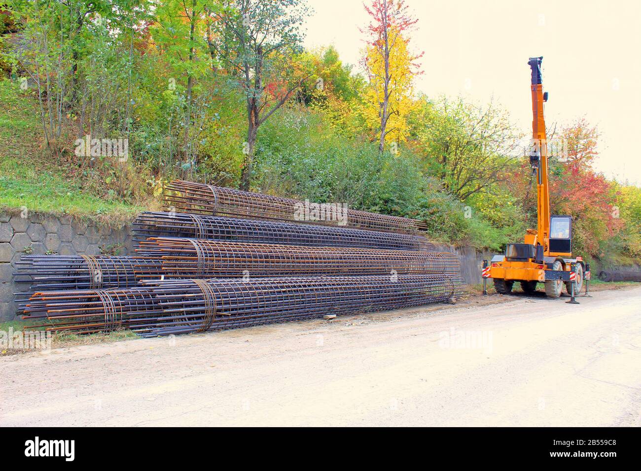 Yellow crane and pylons on construction site Stock Photo - Alamy
