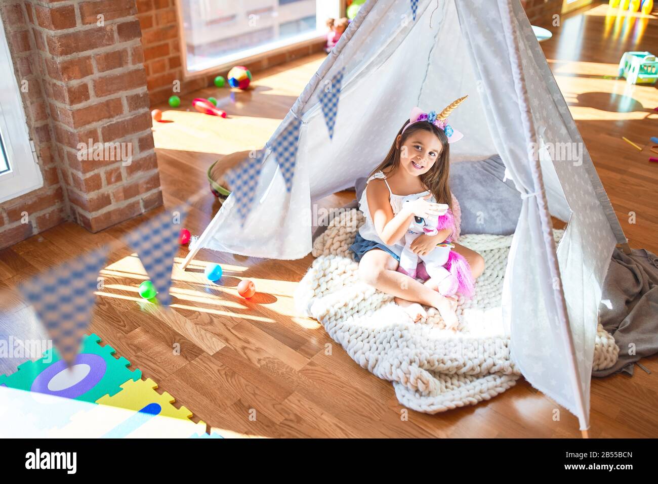 Nursery school children playing dolls hi-res stock photography and ...