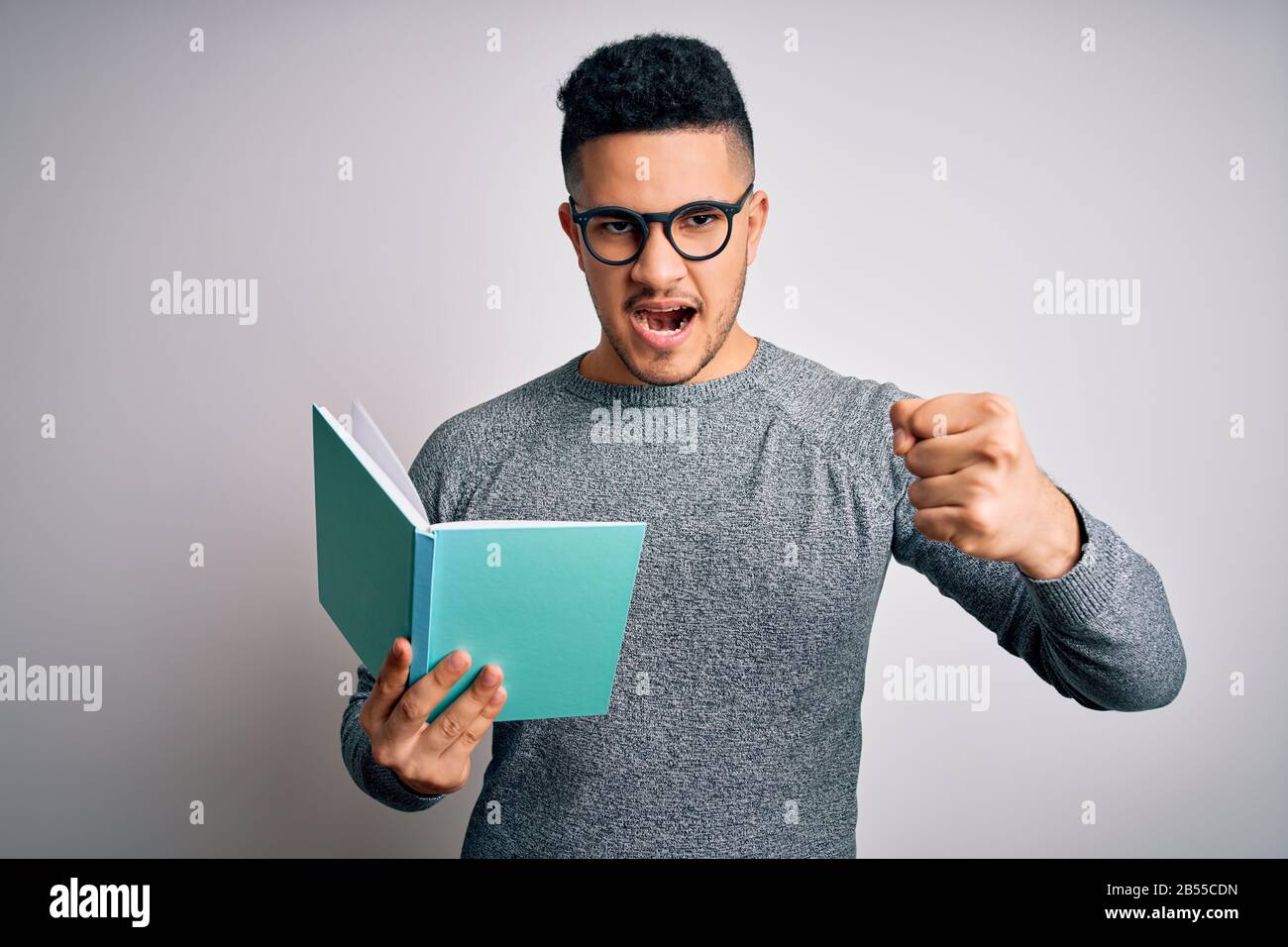 Young handsome smart student man reading book over isolated white ...
