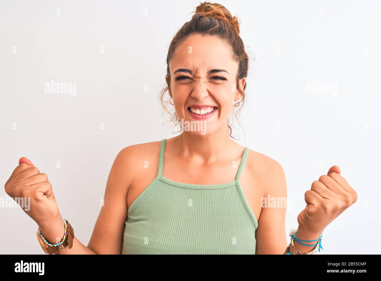 Young redhead woman wearing a bun over isolated background very happy ...