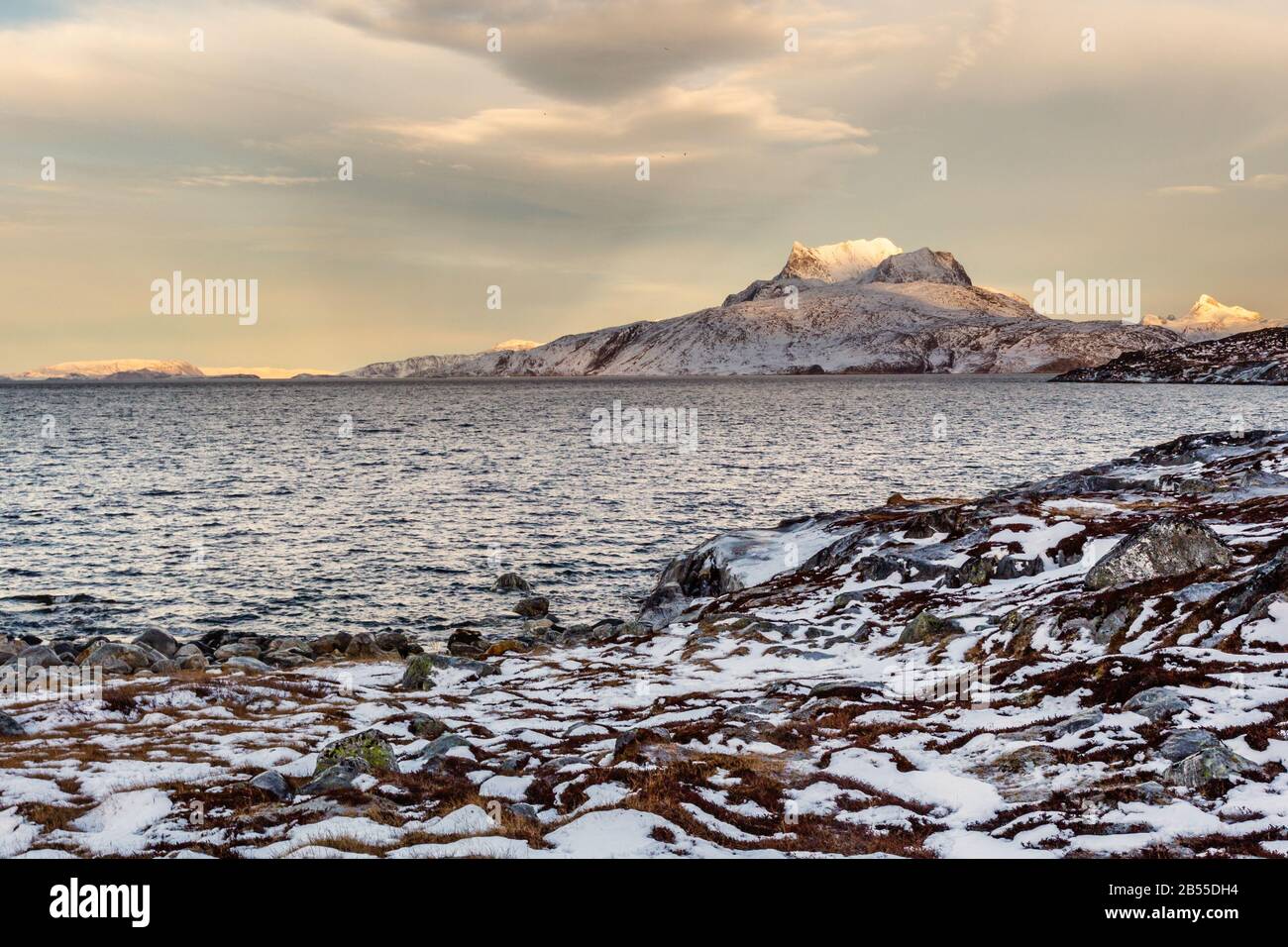 Frozen tundra landscape with cold greenlandic sea and snow Sermitsiaq ...