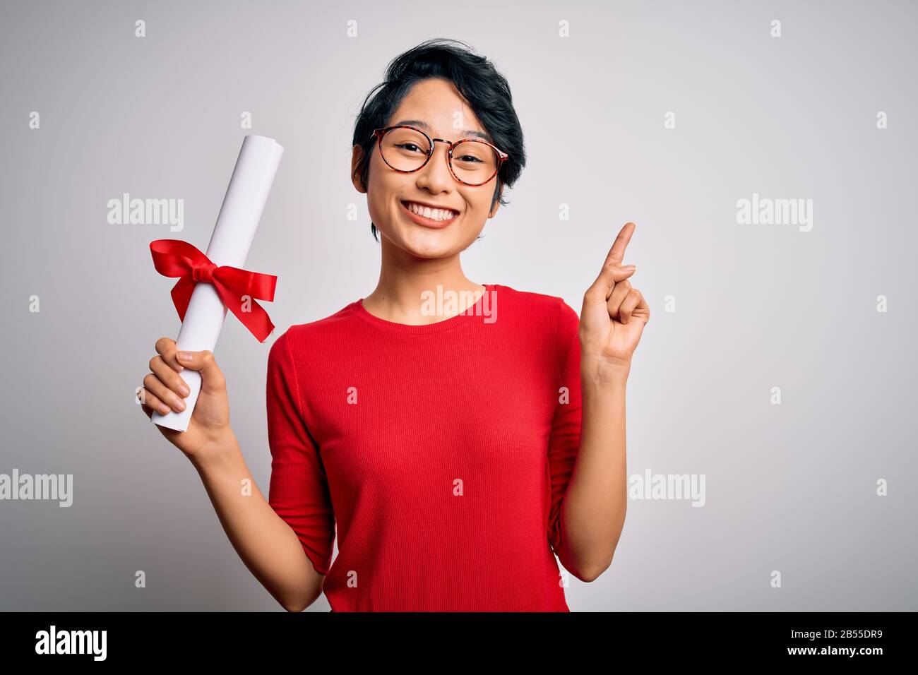 Beautiful chinese student woman wearing glasses holding university ...