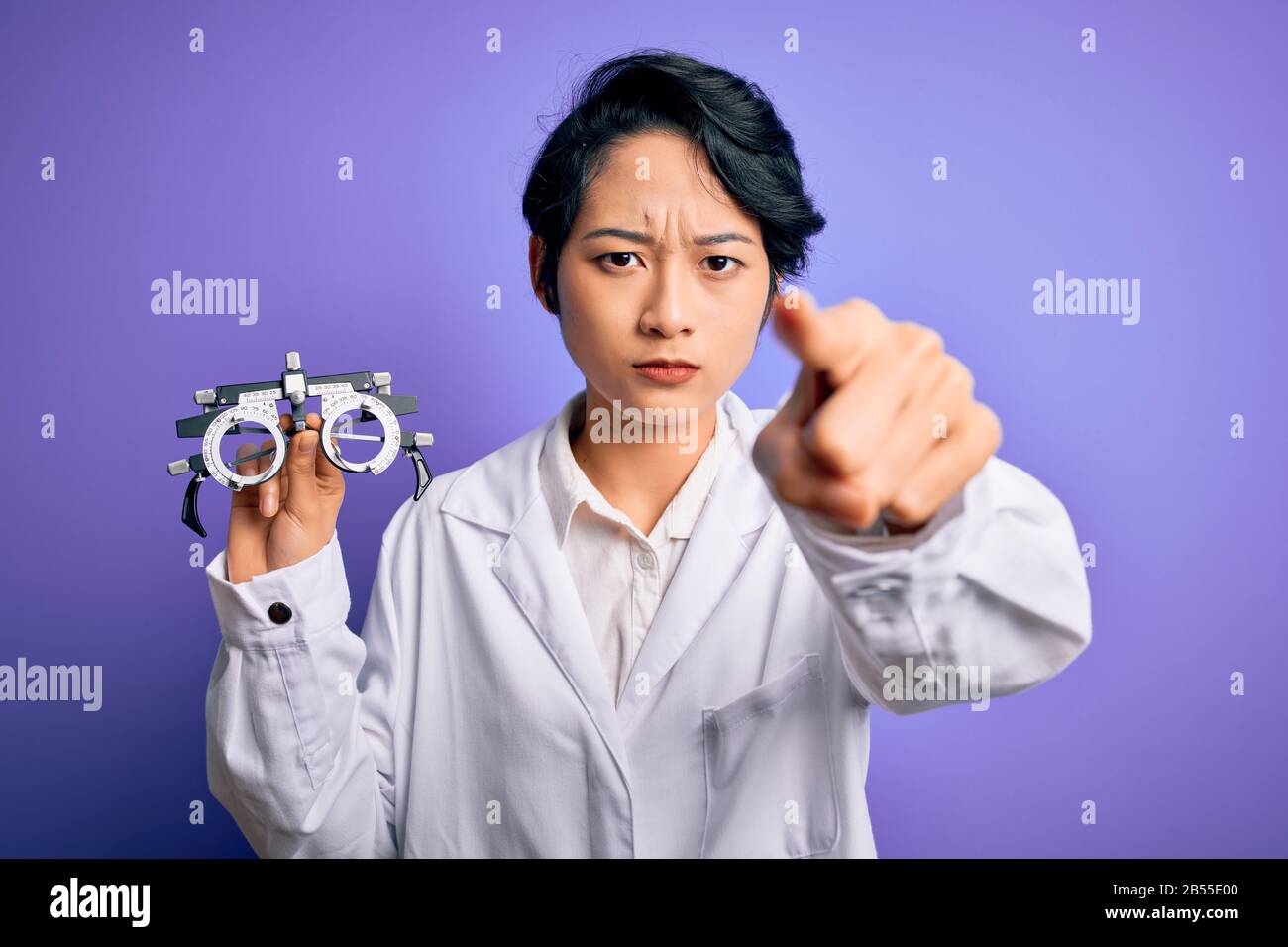Beautiful asian optical girl wearing coat holding optometry glasses ...
