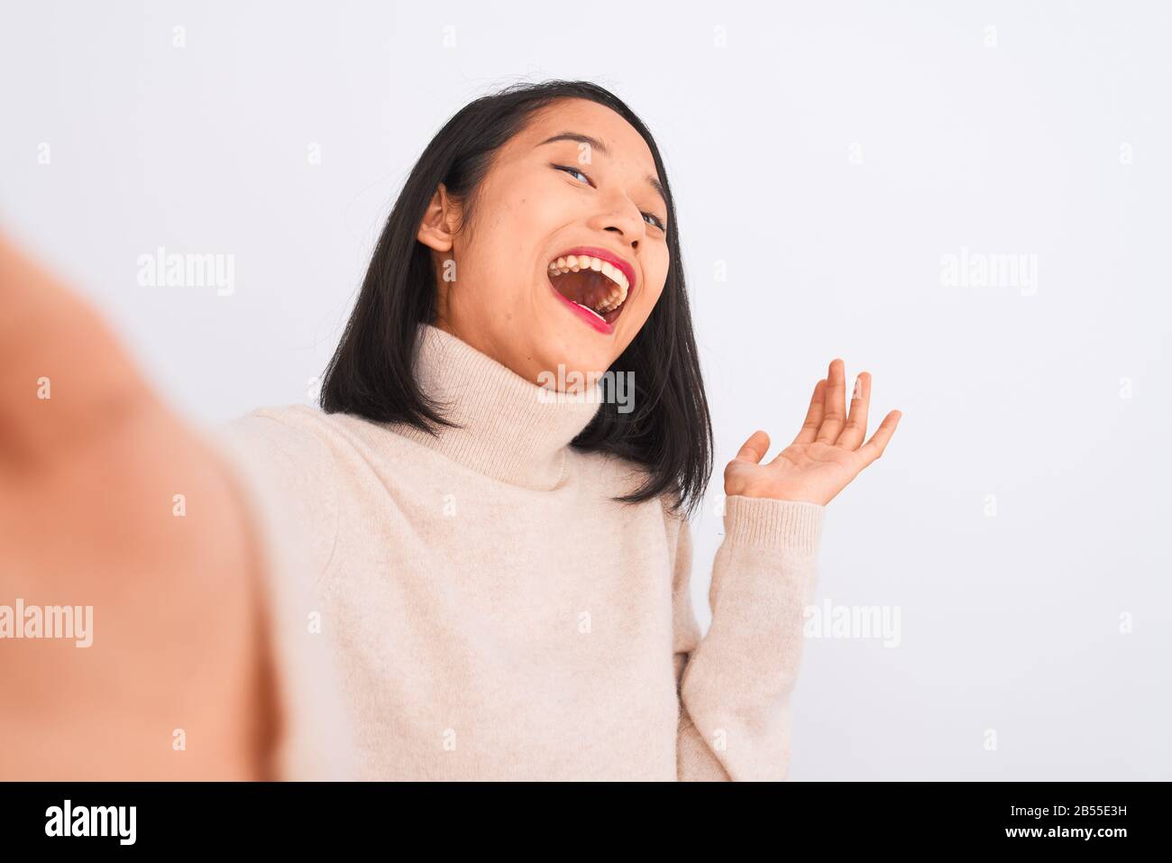 Young chinese woman wearing turtleneck sweater make selfie over ...