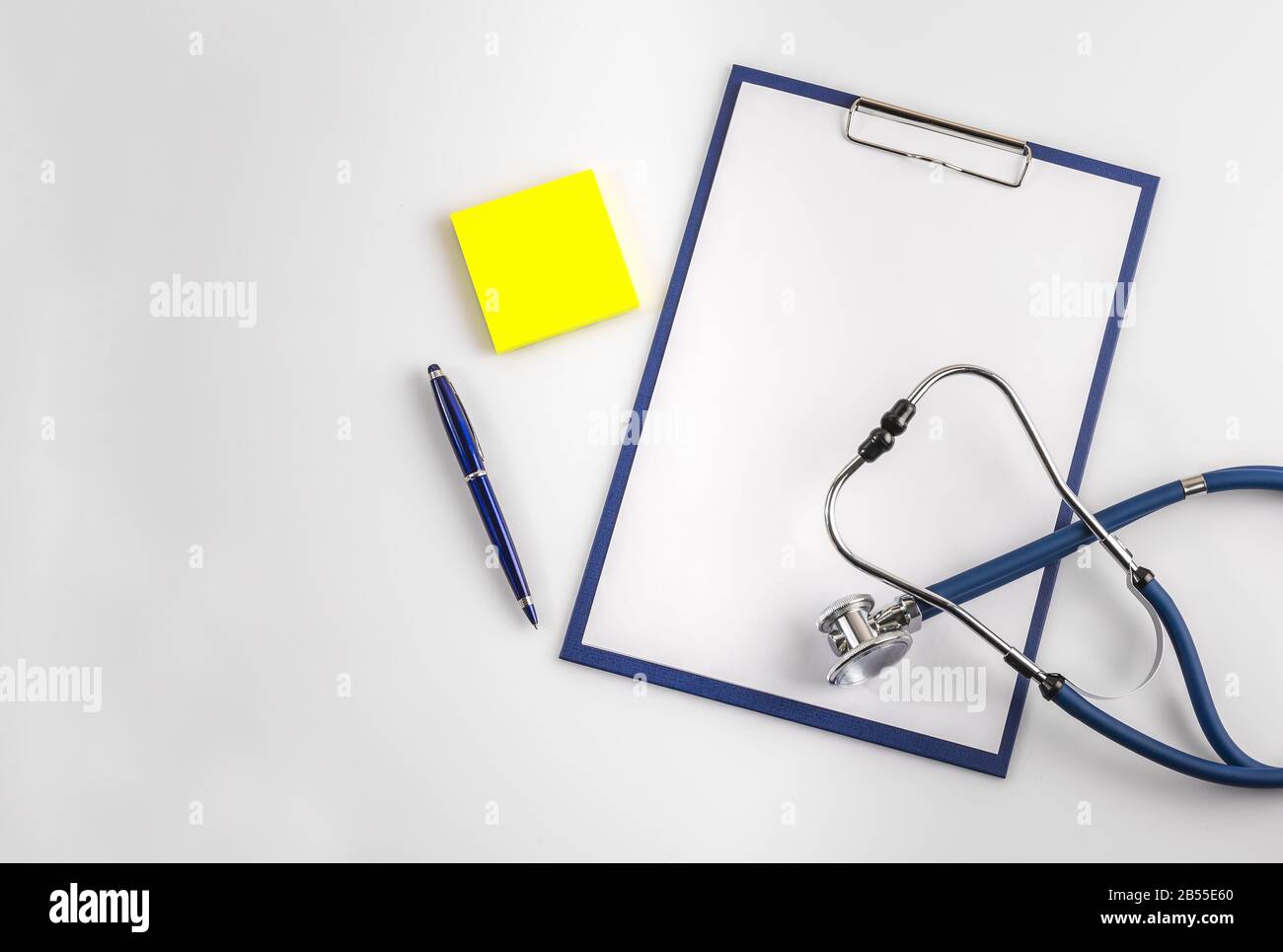 Stethoscope, clipboard, pen and sticky notes on white background ...