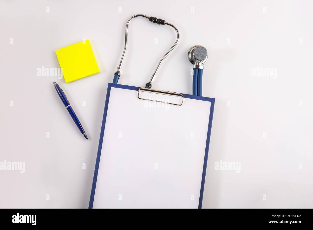 Stethoscope, clipboard, pen and sticky notes on white background ...