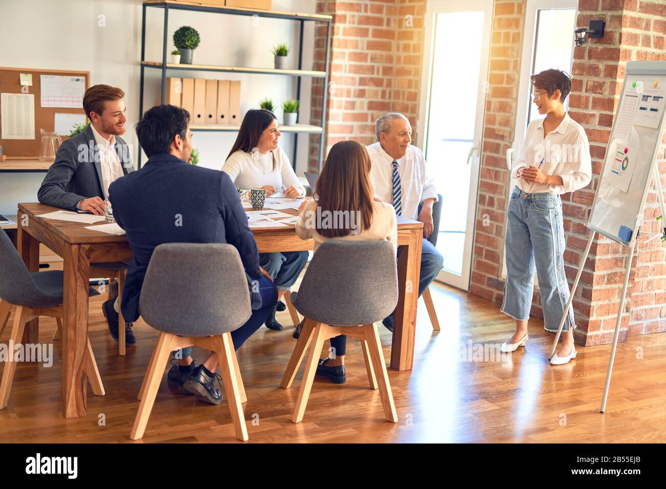 Group of business workers working together in a meeting. One of them ...