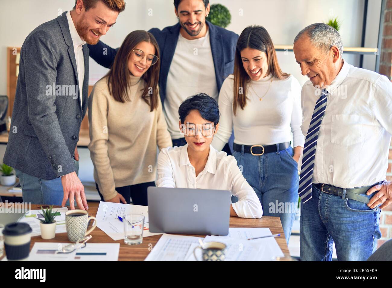 Group of business workers smiling happy and confident. One of them ...