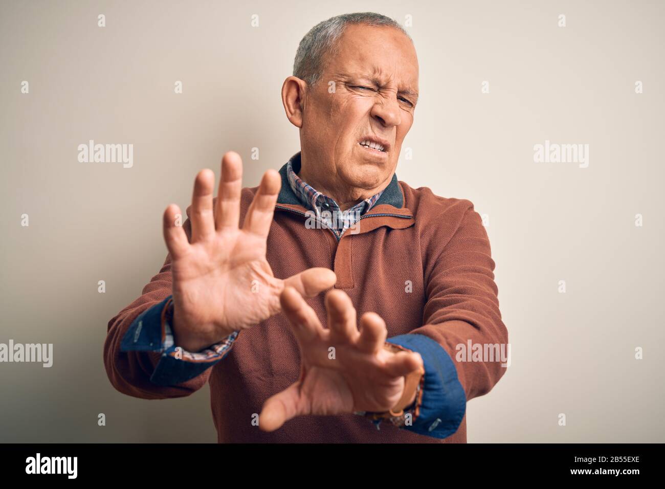 Senior handsome man wearing elegant sweater standing over isolated ...
