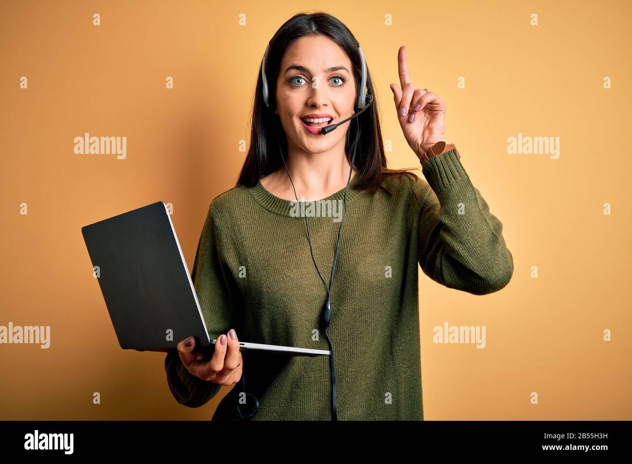 Young operator woman with blue eyes working on call center using ...