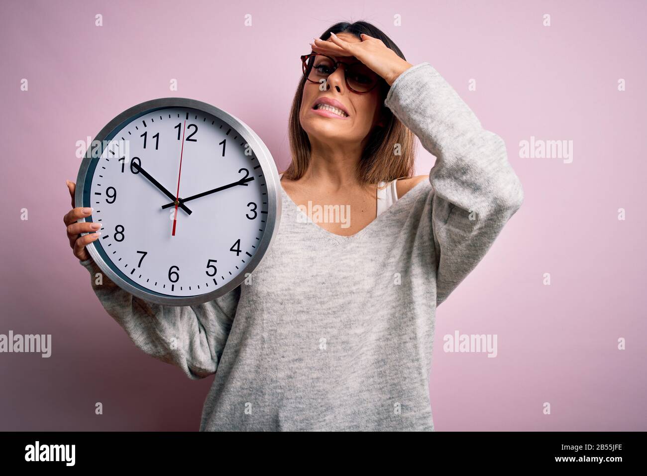 Young beautiful brunette woman wearing glasses doing countdown using ...