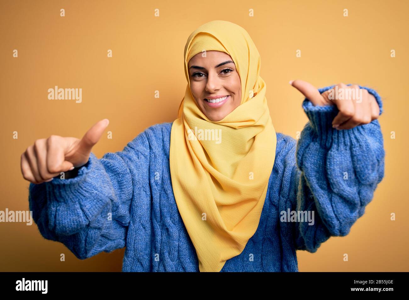 Young beautiful brunette muslim woman wearing arab hijab over isolated ...