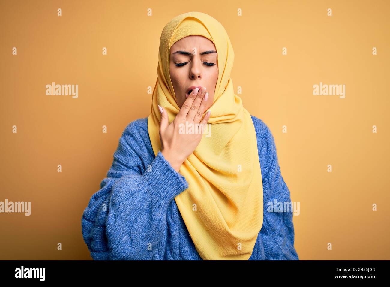 Young beautiful brunette muslim woman wearing arab hijab over isolated ...