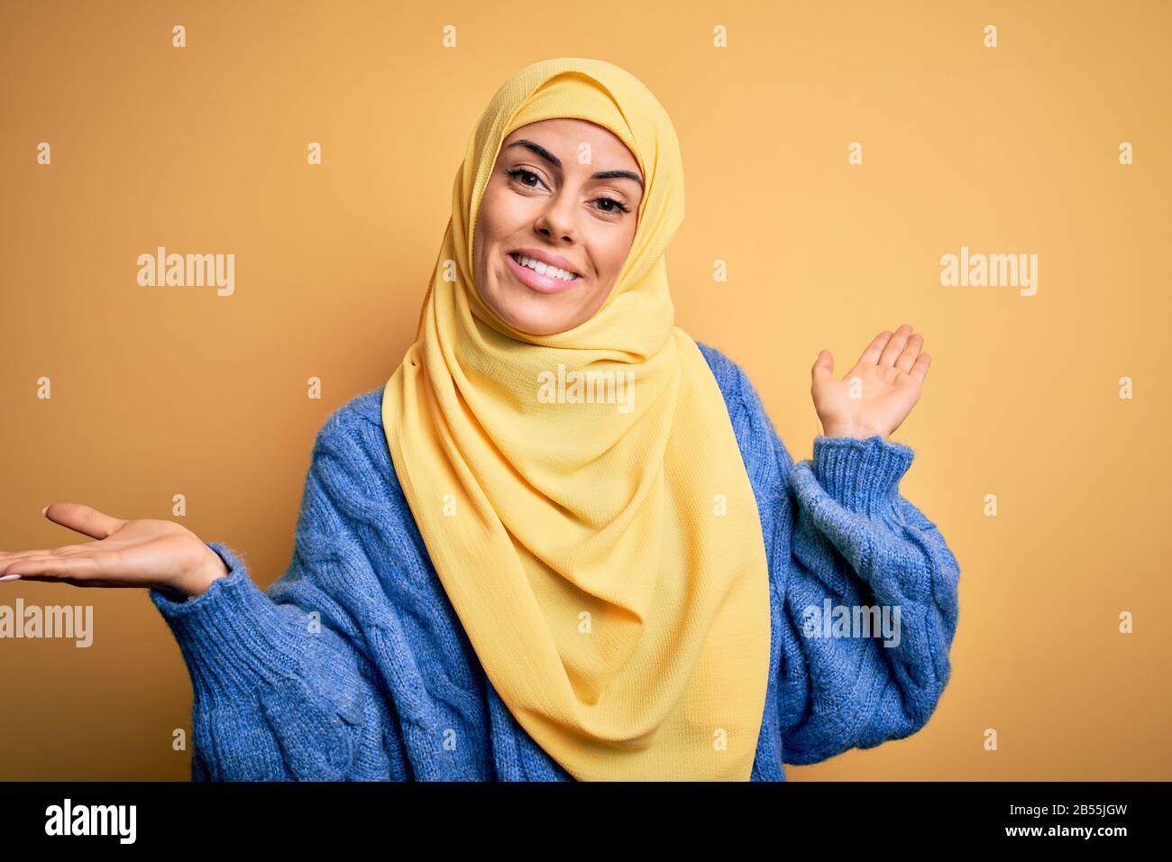 Young beautiful brunette muslim woman wearing arab hijab over isolated ...