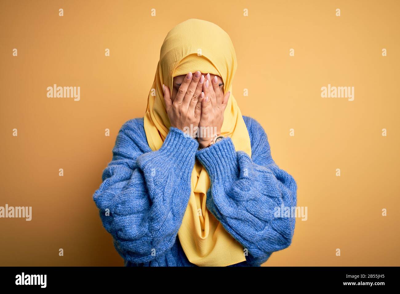Young beautiful brunette muslim woman wearing arab hijab over isolated ...