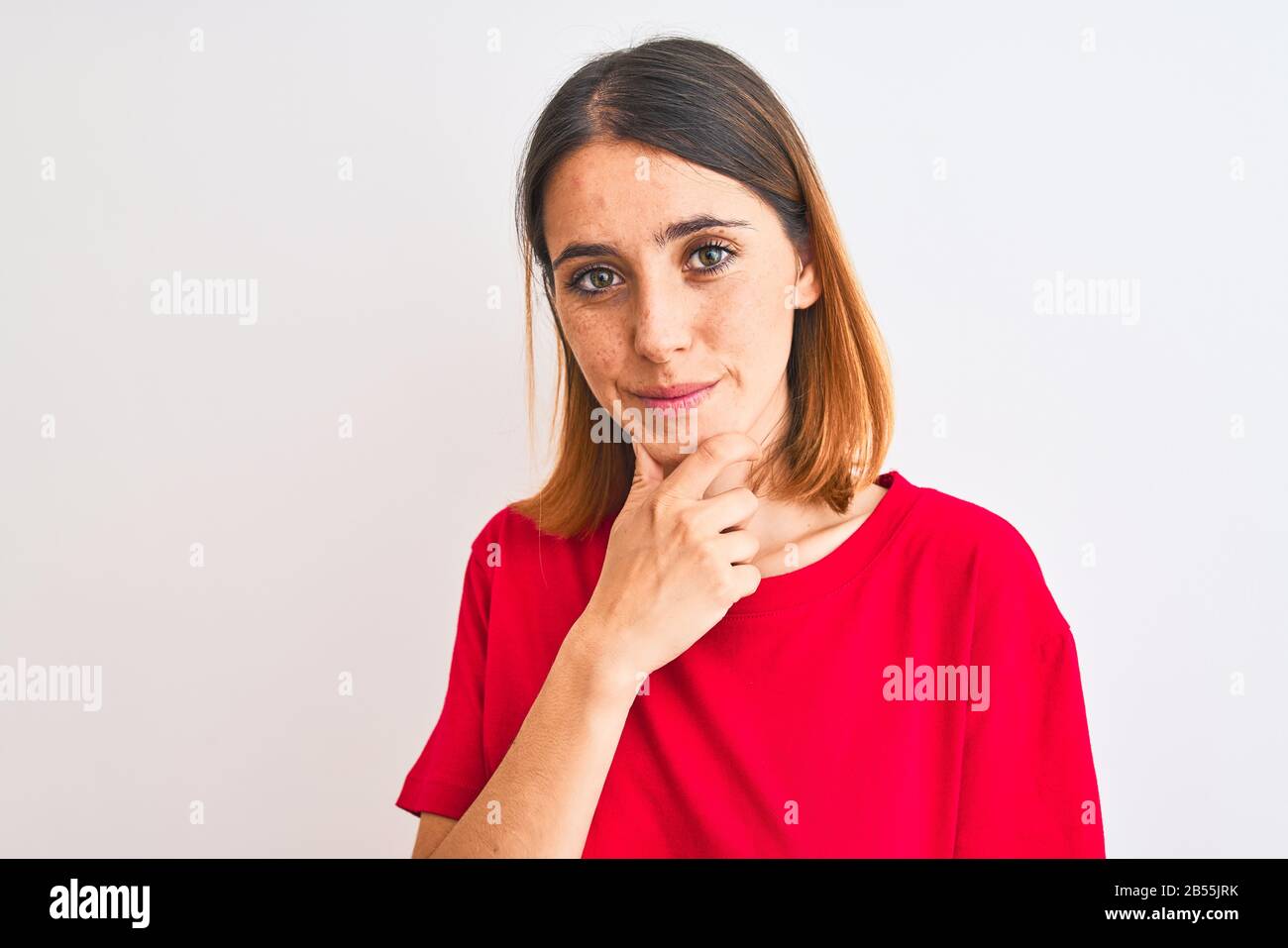 Beautiful redhead woman wearing casual red t-shirt over isolated ...