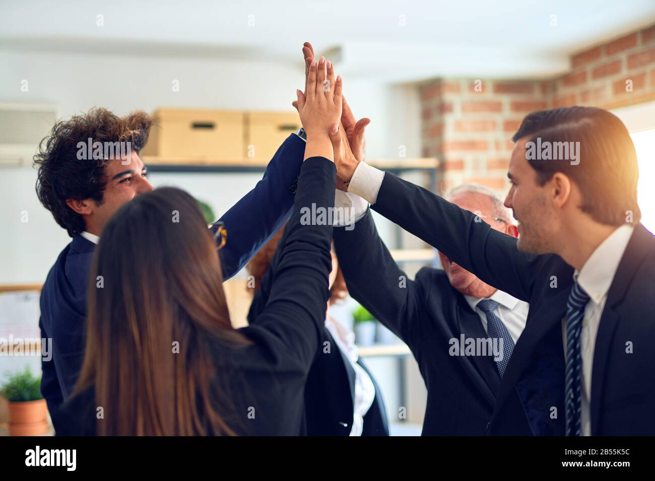 Group of business workers smiling happy and confident. Standing on a ...