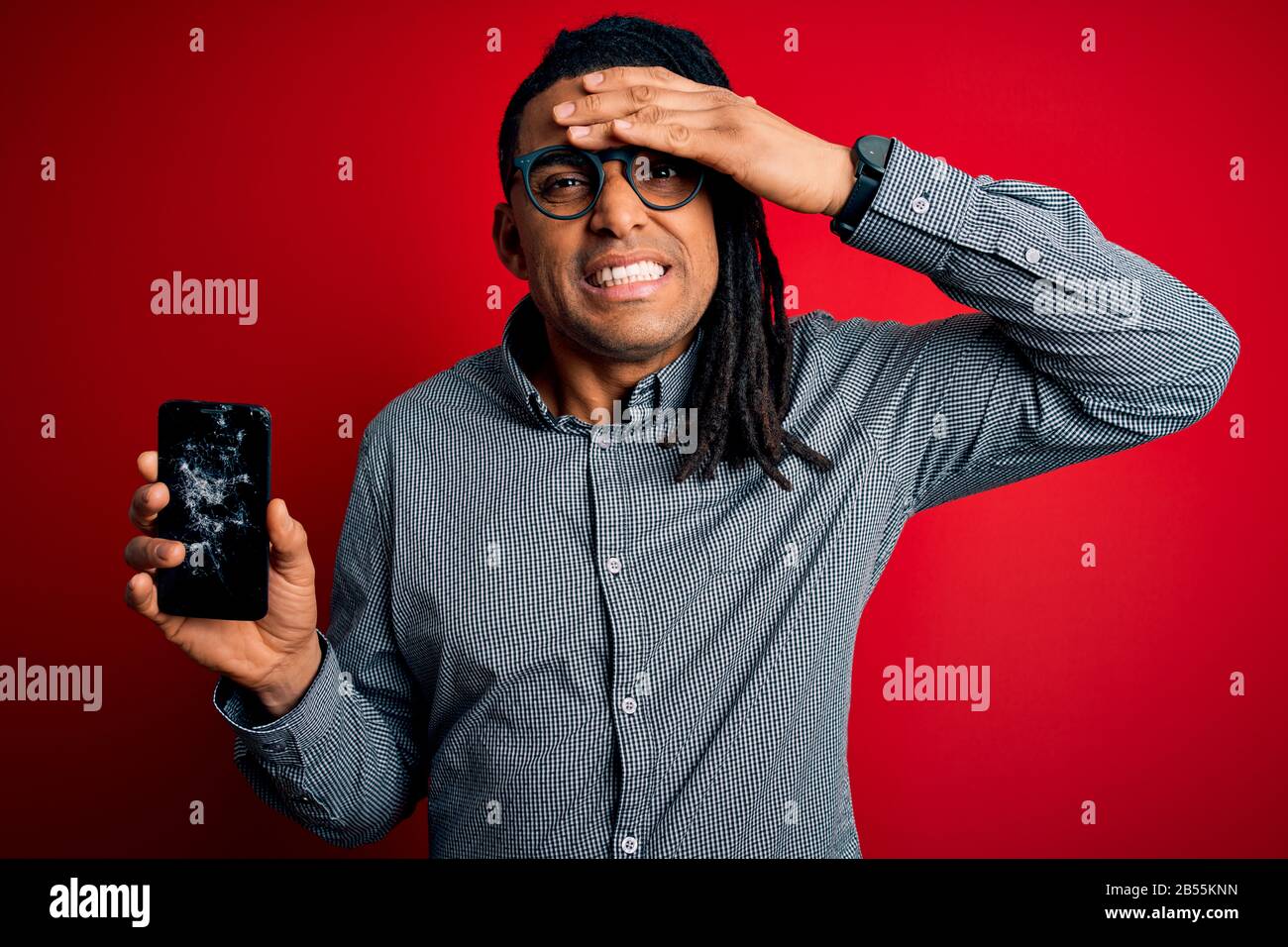 Young african american afro man holding broken smartphone showing ...