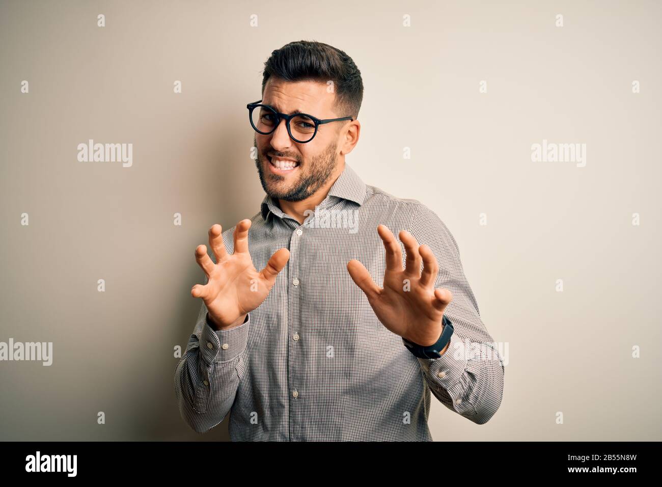 Young handsome man wearing elegant shirt and glasses over isolated ...