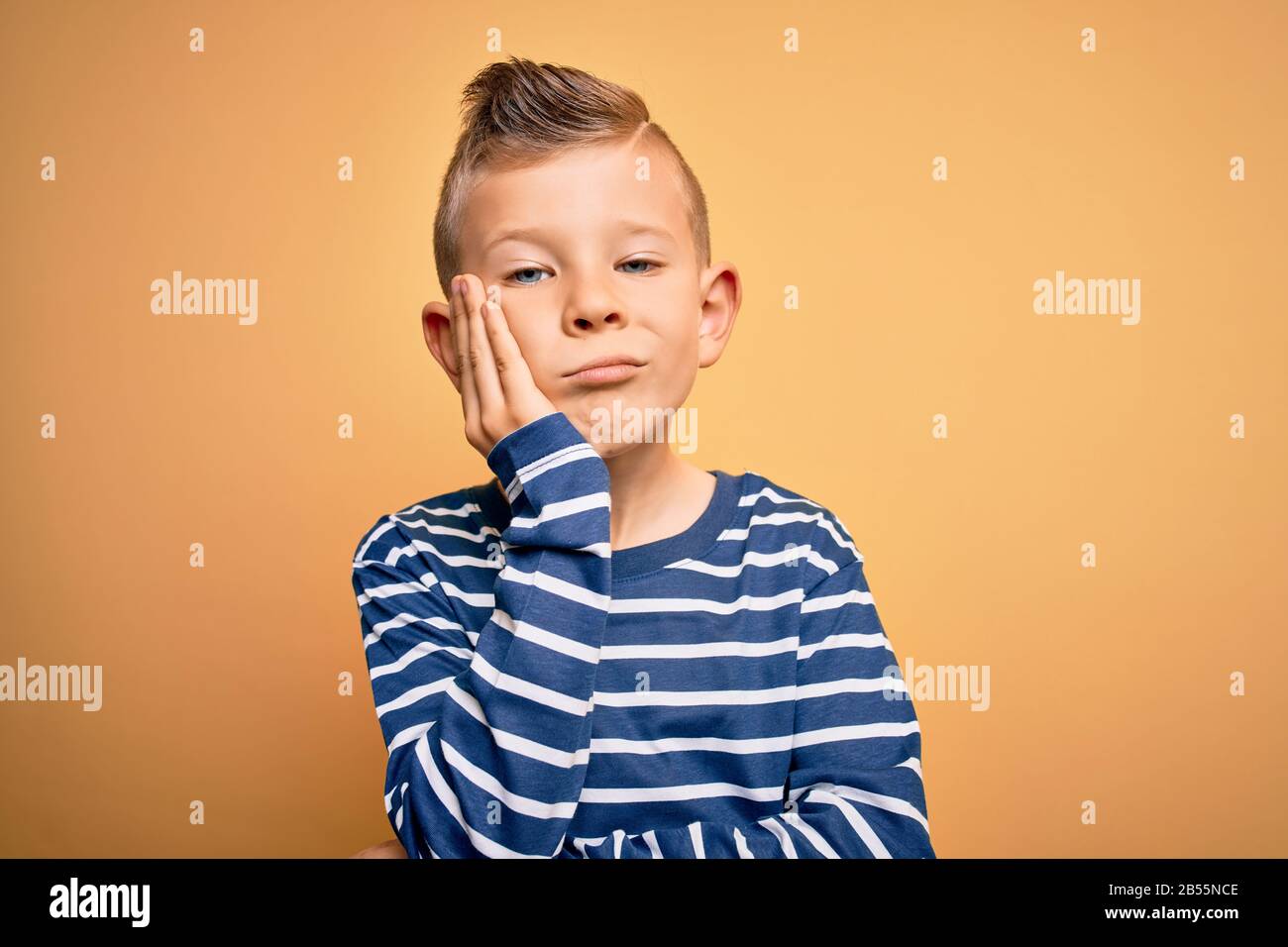 Young little caucasian kid with blue eyes wearing nautical striped ...