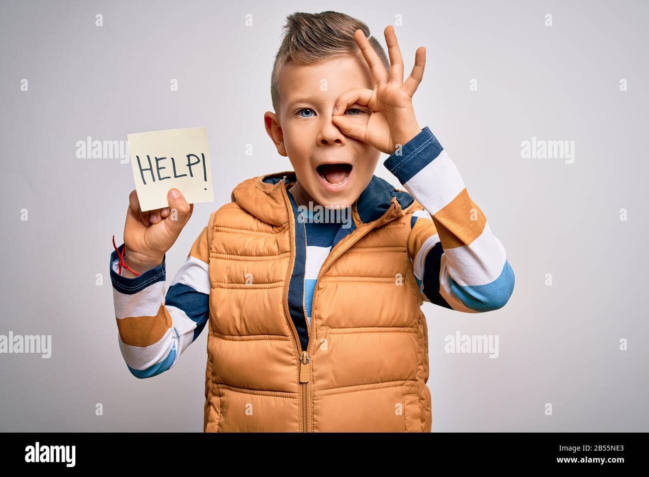 Young little caucasian kid asking for help on a paper note as violence ...