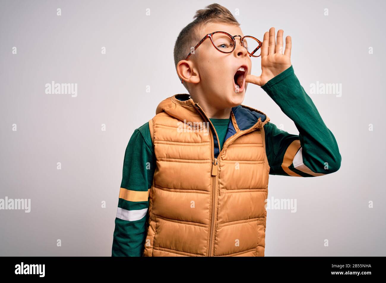 Young little caucasian kid with blue eyes wearing winter coat and smart ...