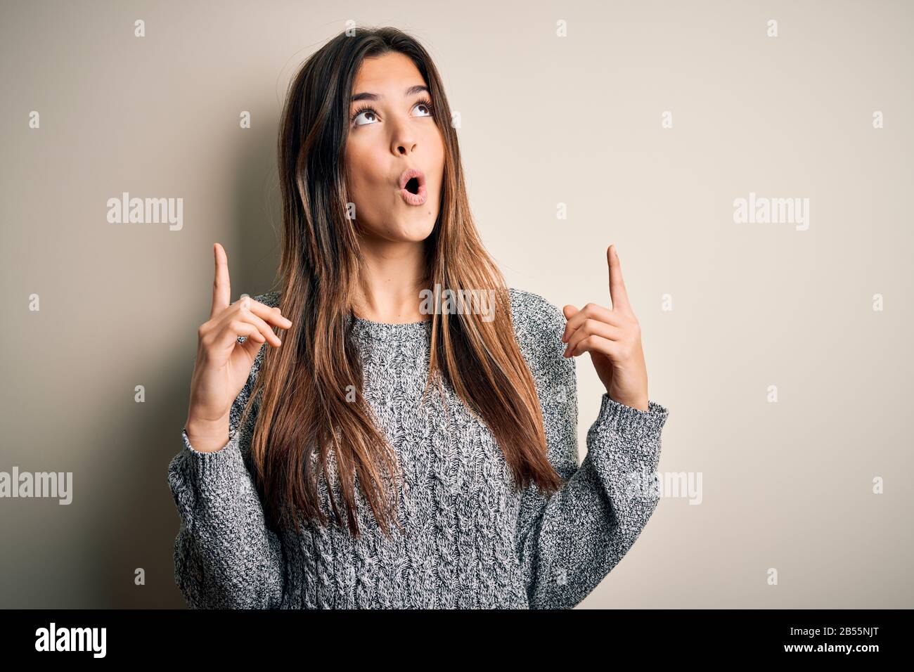 Young beautiful girl wearing casual sweater standing over isolated ...