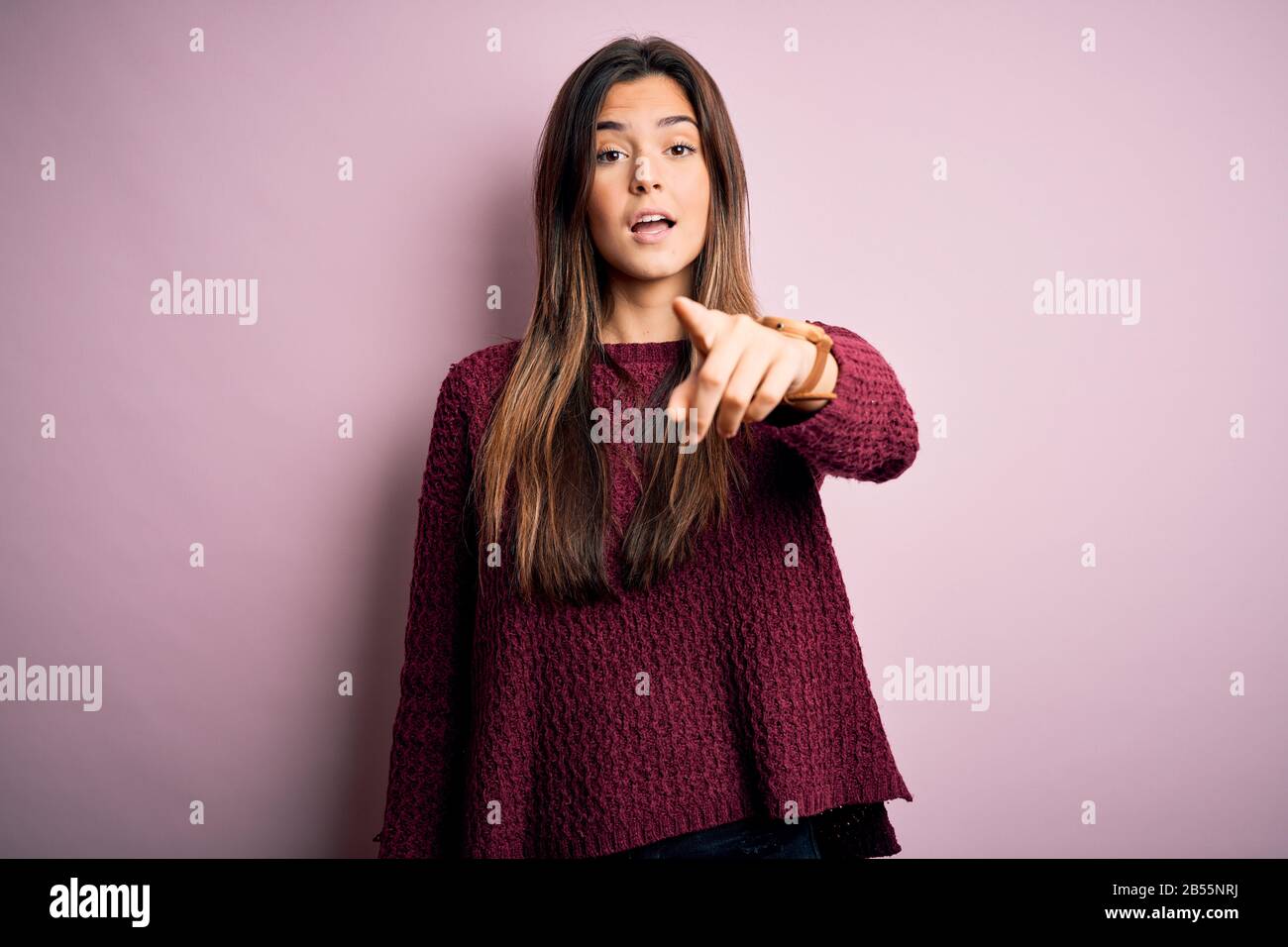 Young beautiful girl wearing casual sweater over isolated pink ...