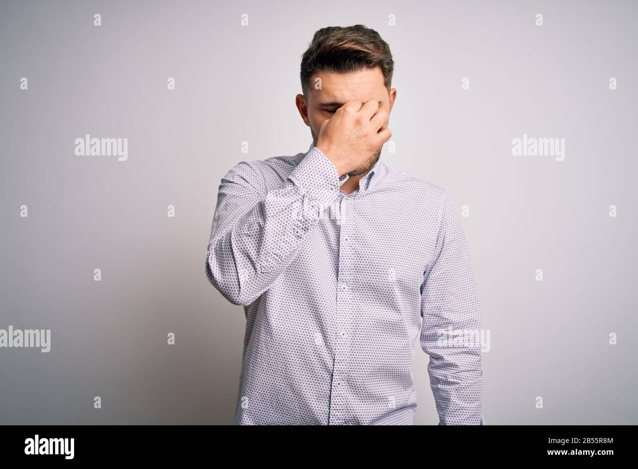 Young business man with blue eyes standing over isolated background ...