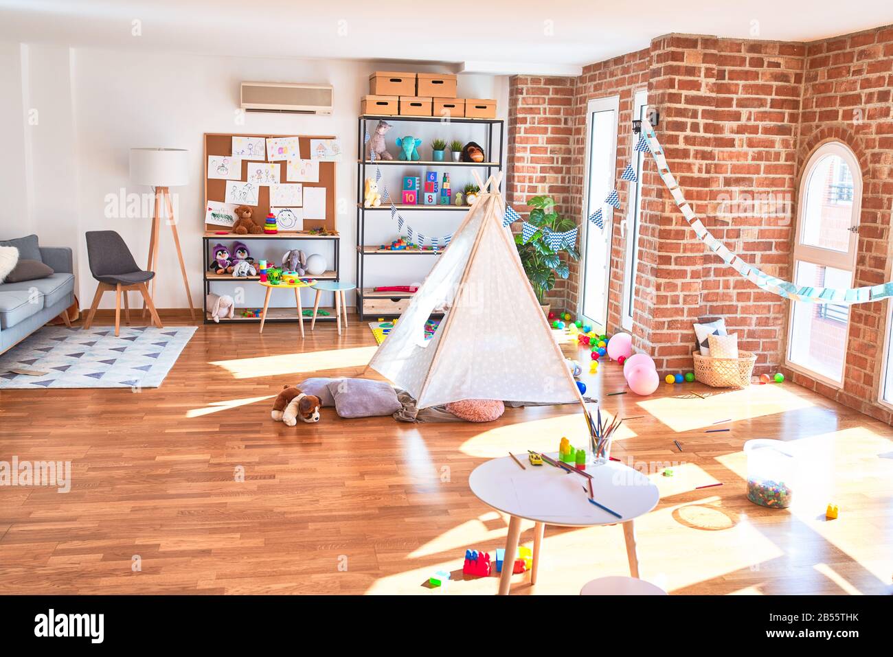 Picture of preschool playroom with colorful furniture and toys around ...