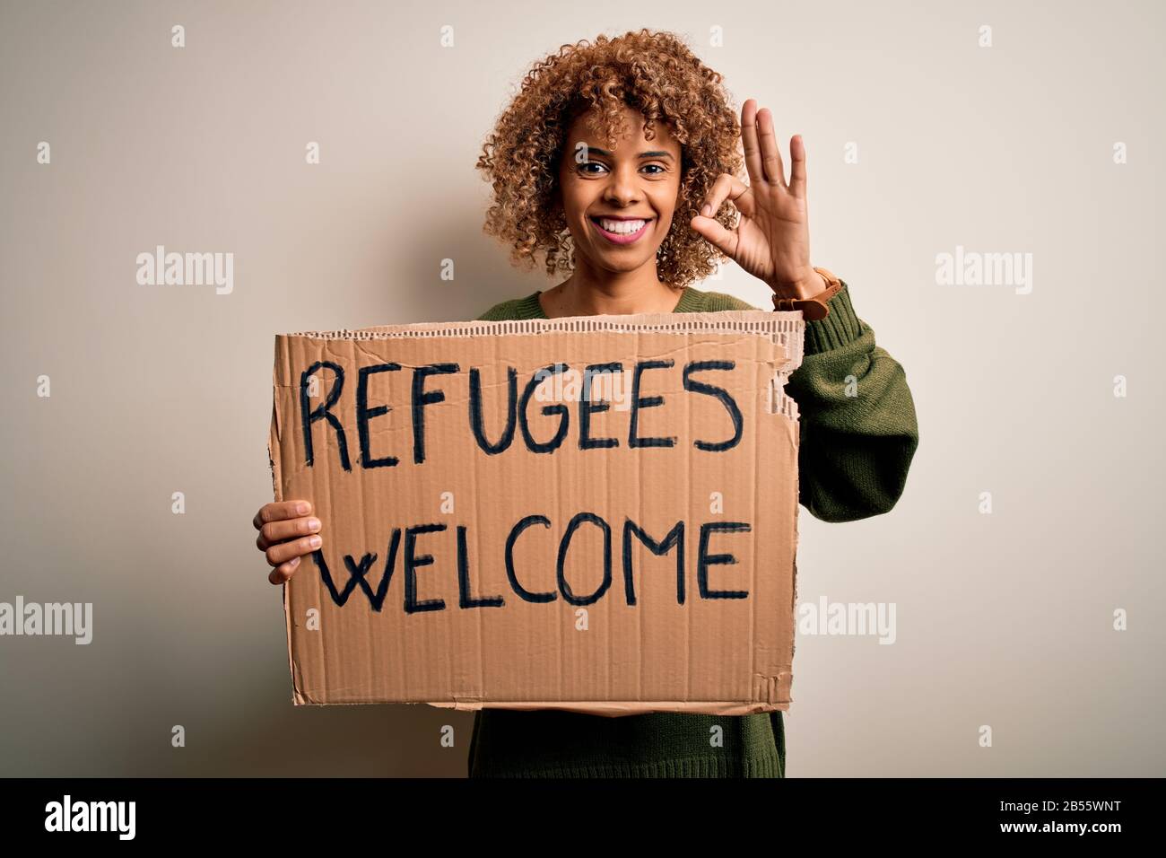 African american woman asking for immigration holding banner with ...
