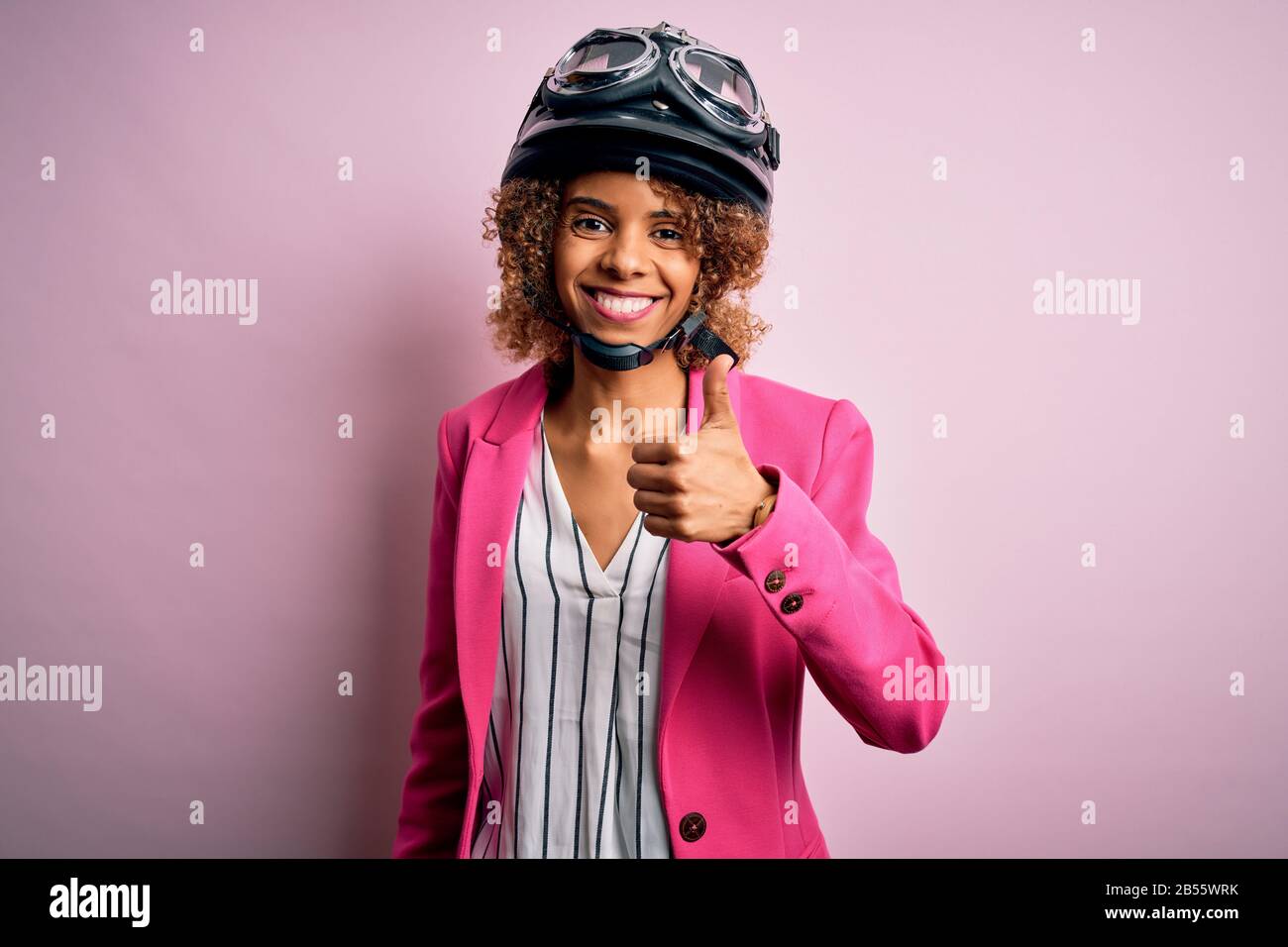 African american motorcyclist woman with curly hair wearing moto helmet ...