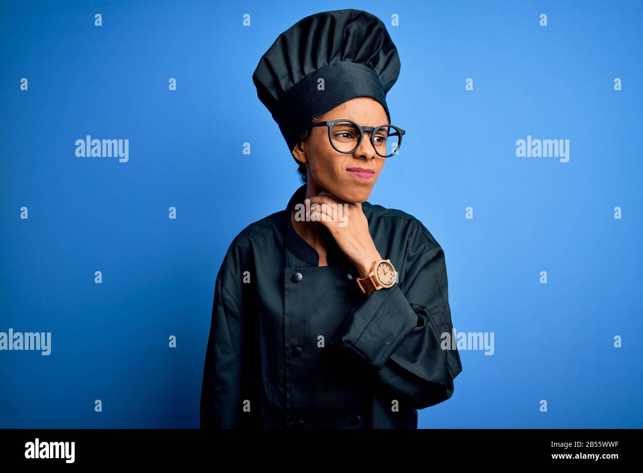 Young african american chef woman wearing cooker uniform and hat over ...