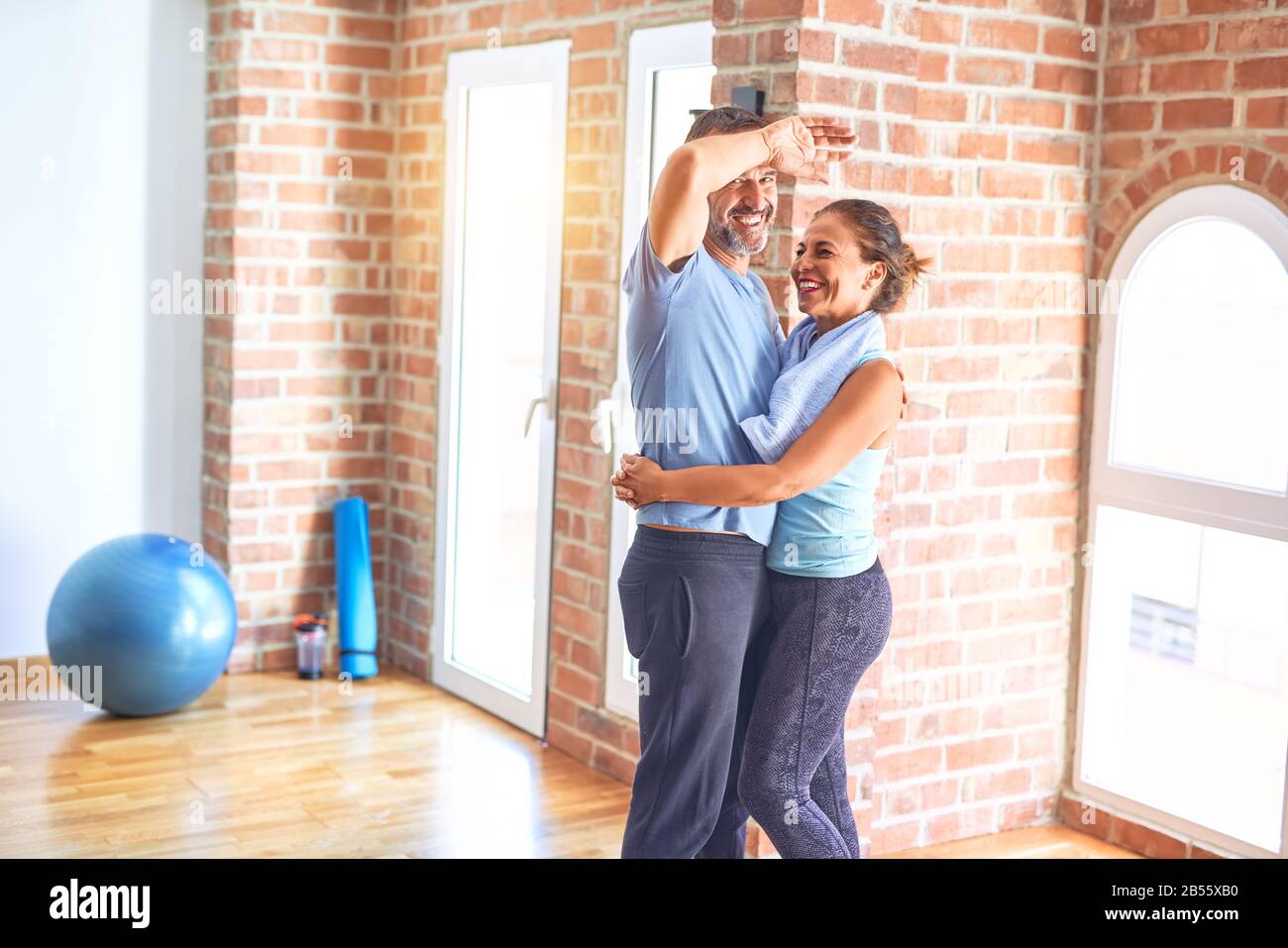 Middle age beautiful sporty couple smiling happy. Standing with smile ...