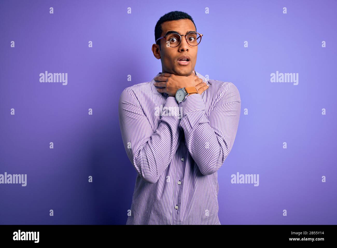 Handsome african american man wearing striped shirt and glasses over ...