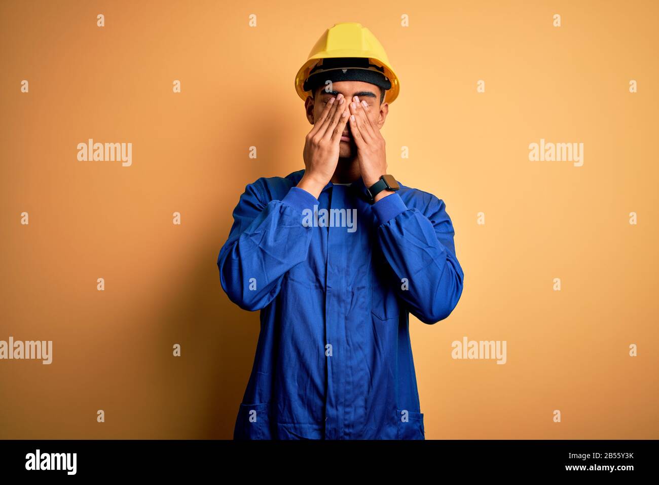 Young handsome african american worker man wearing blue uniform and ...