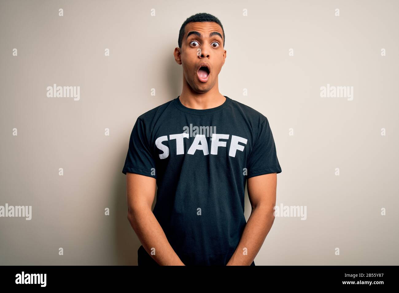 Young handsome african american worker man wearing staff uniform over ...