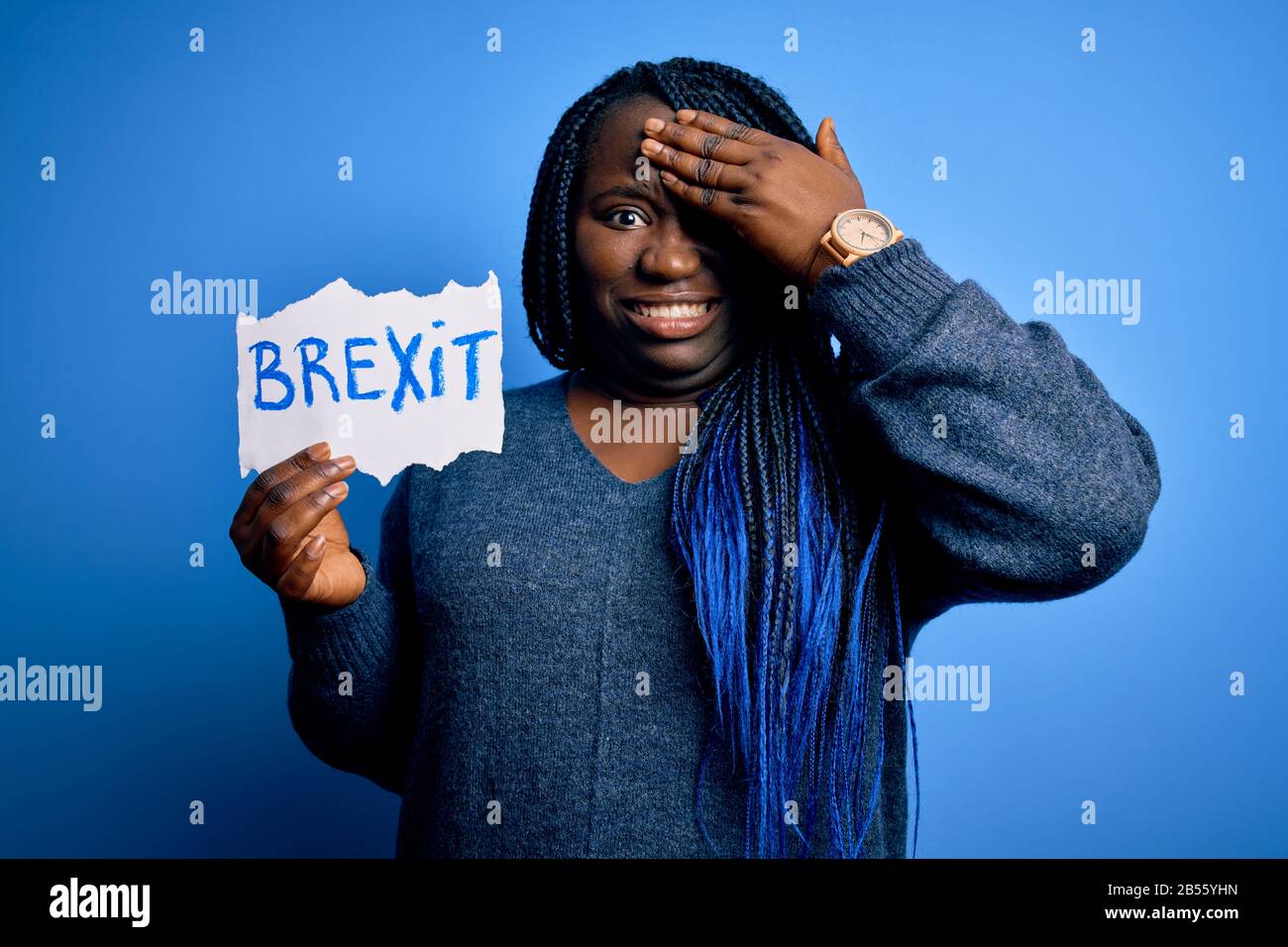 Young african american plus size woman with braids holding paper with ...