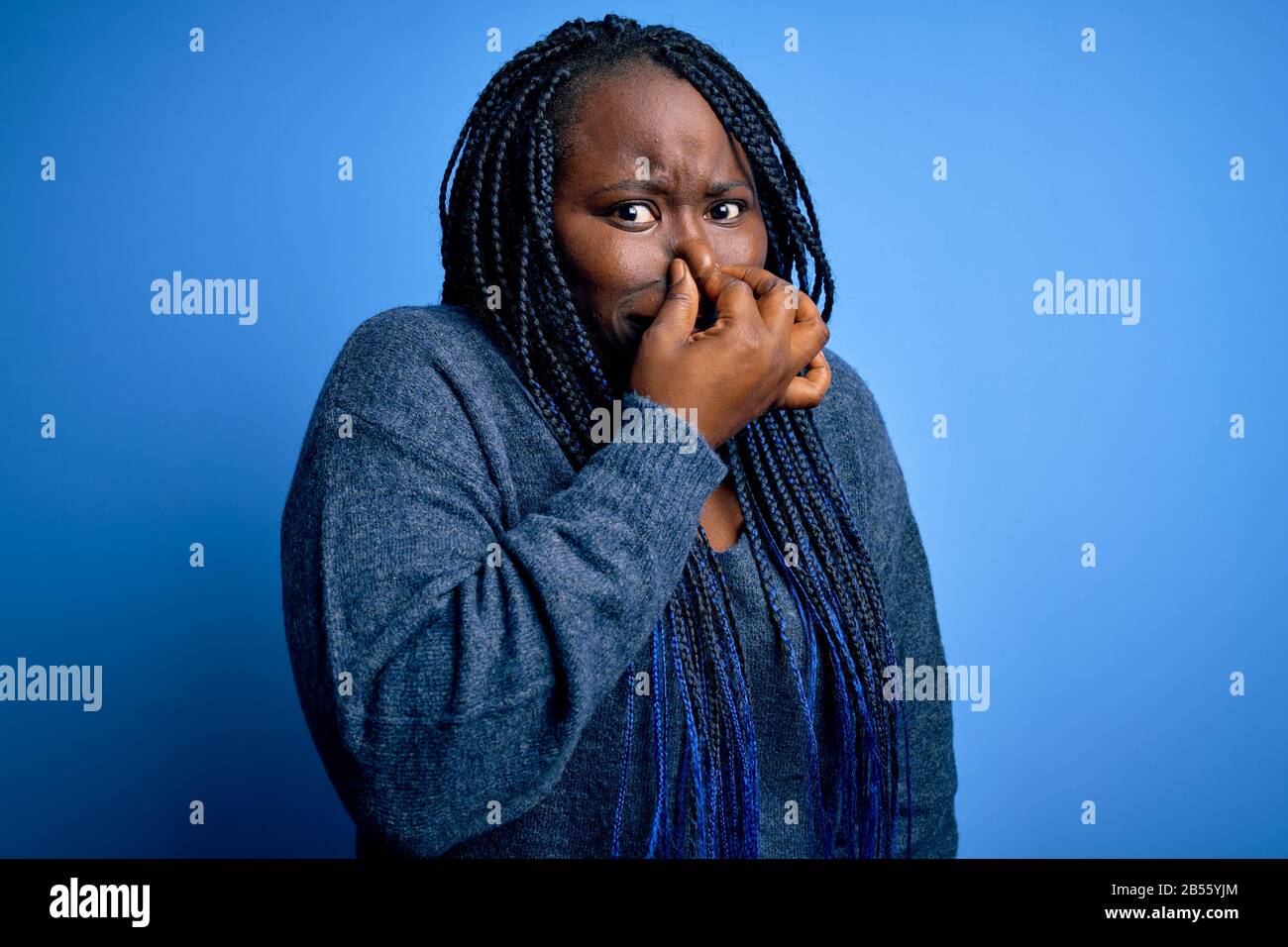 African american plus size woman with braids wearing casual sweater ...