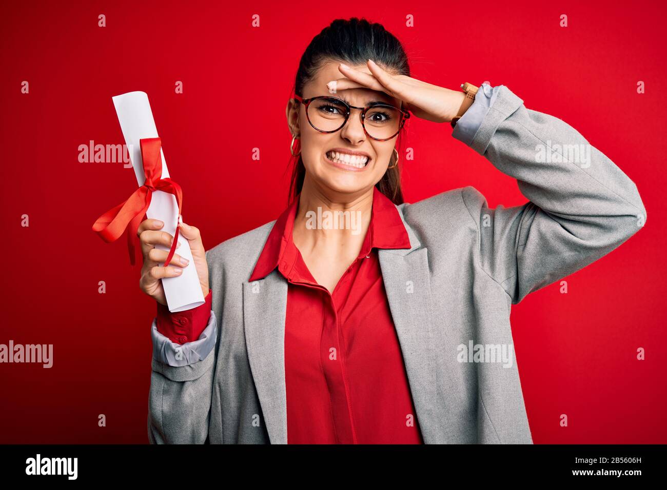 Young beautiful brunette student woman wearing glasses holding ...