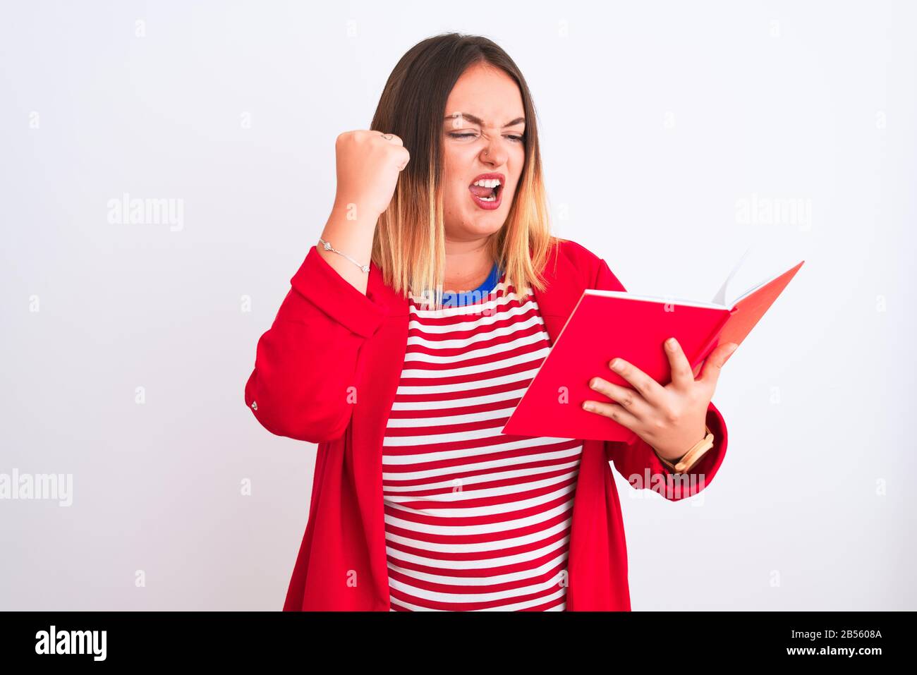 Young beautiful woman reading book standing over isolated white ...