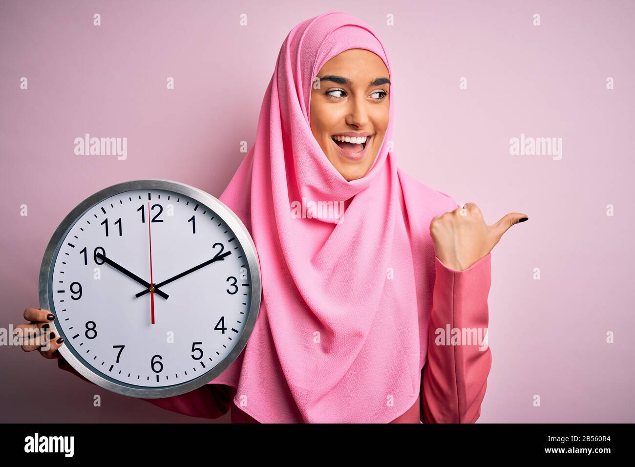 Young beautiful arab woman wearing pink muslim hijab doing countdown ...