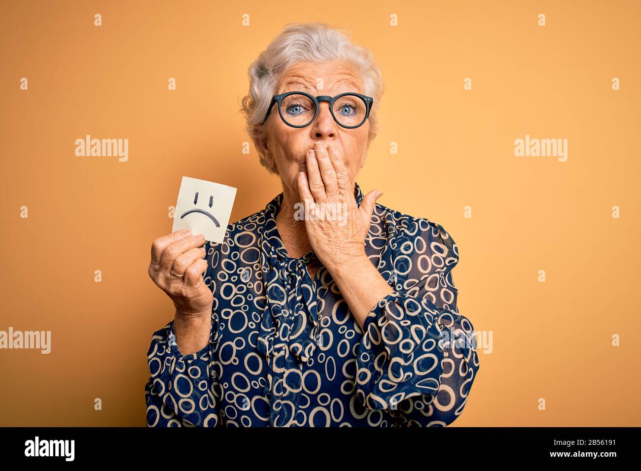 Senior beautiful grey-haired woman holding reminder paper with sad ...