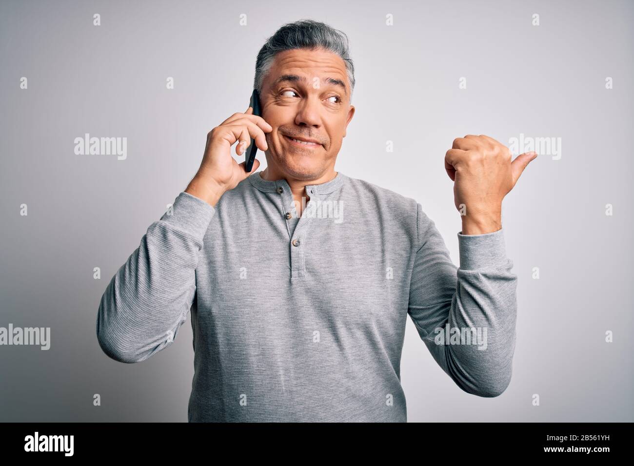 Middle age handsome grey-haired man having conversation talking on the ...